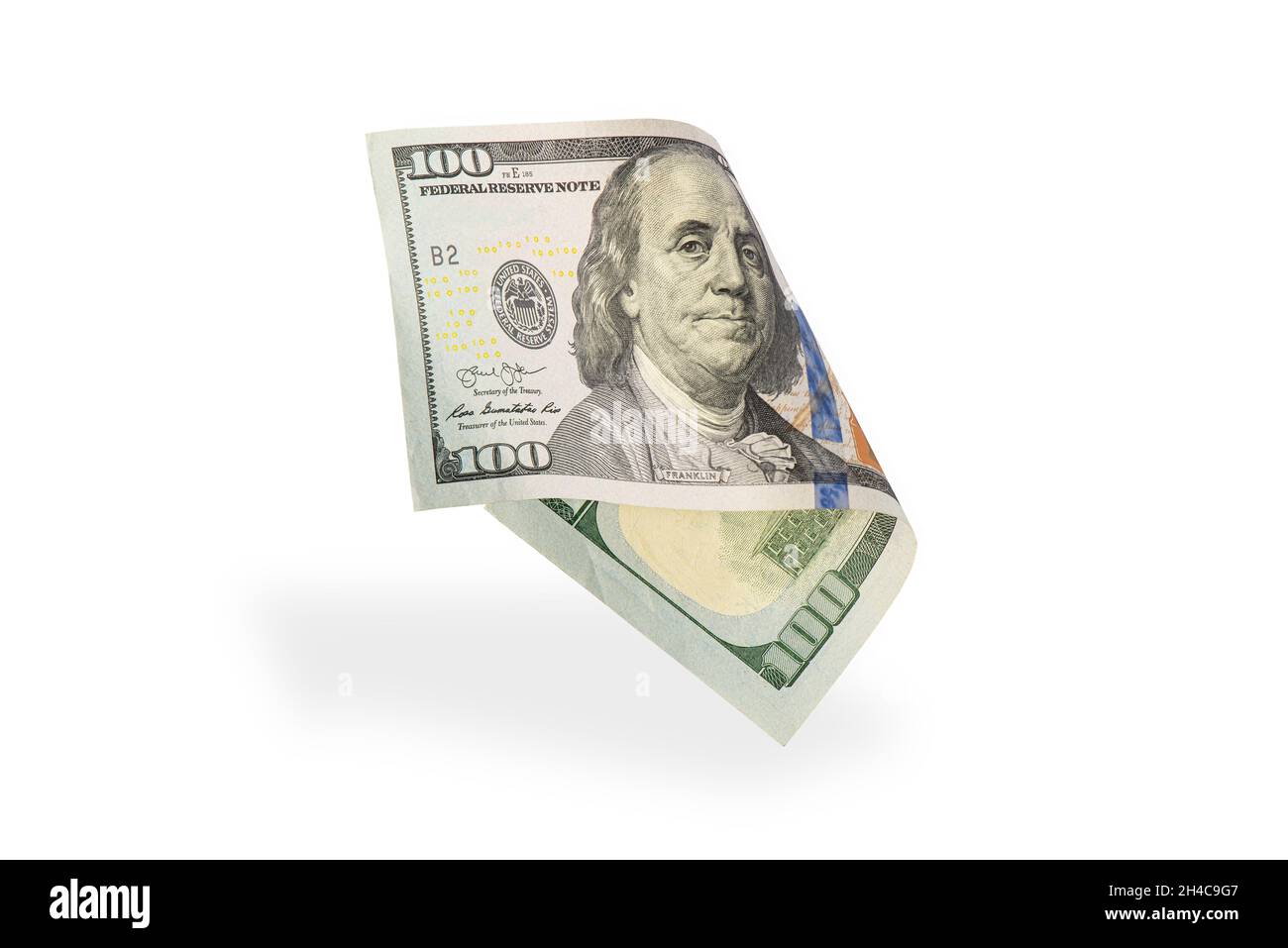 Hundred dollar bill falling casting shadow, half-folded bill close-up ...