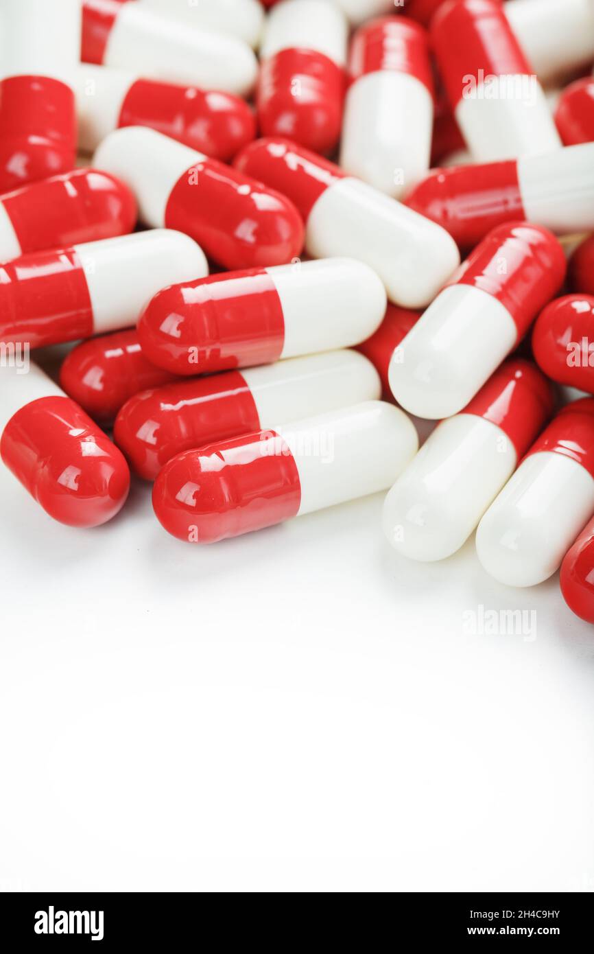 Red and white tablets on a white background with free space. Top view ...