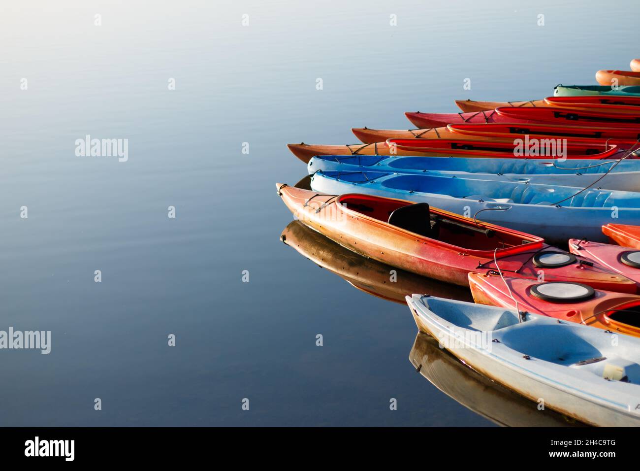 Row of colorful kayaks on a California coast Stock Photo - Alamy