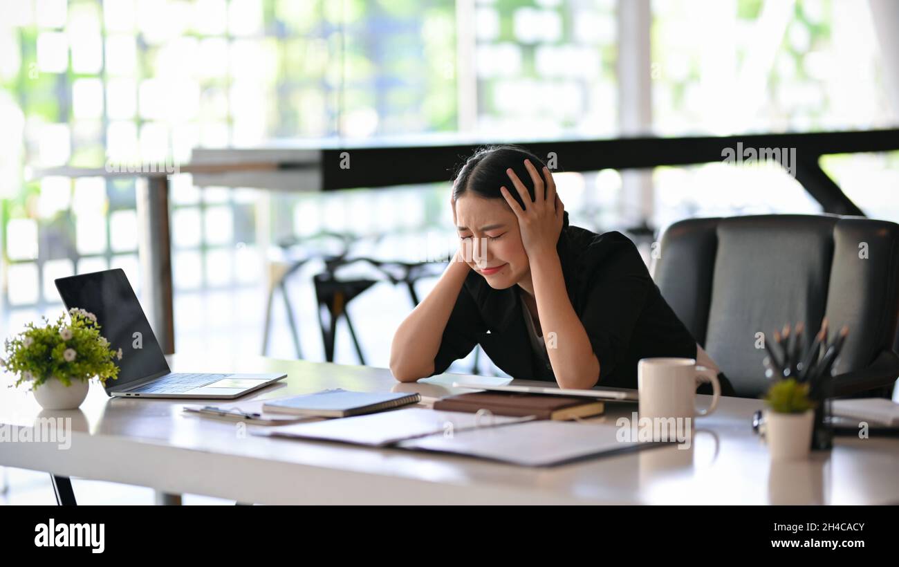 Business woman feeling shocked and stressed after reading business sale ...