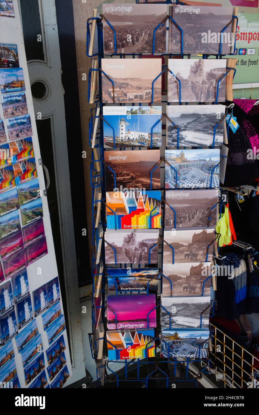 Postcards for sale on a display stand at seaside shop in Scarborough ...