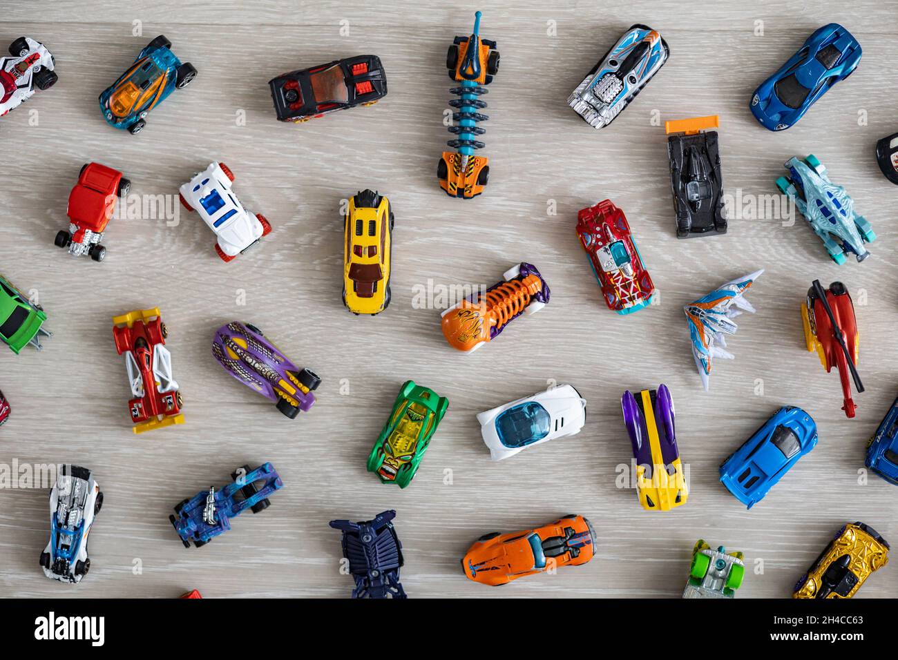 Top view random collection of model sport car toy hot wheels on wooden ...
