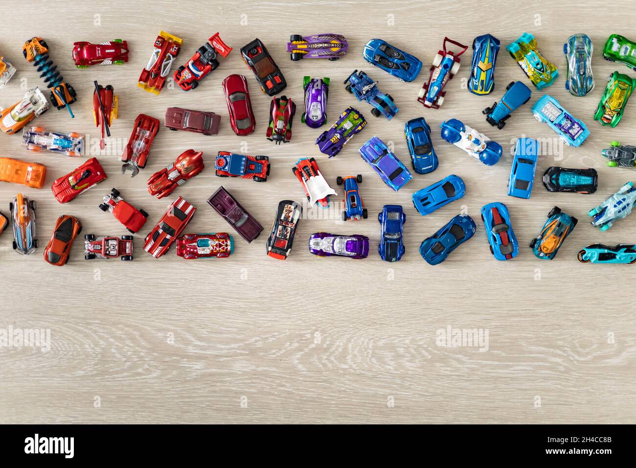 Top view random collection of model sport car toy hot wheels on wooden ...