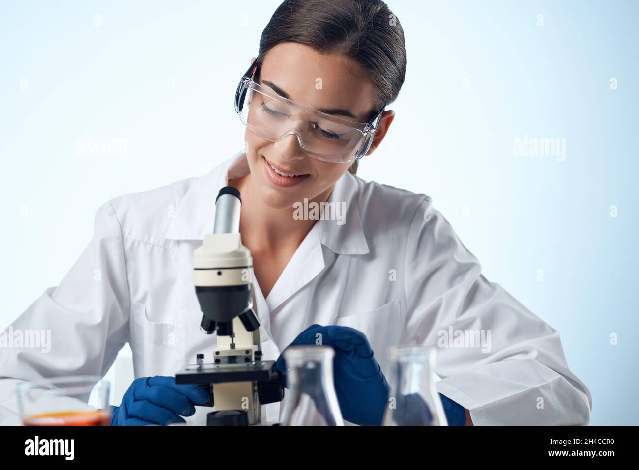 laboratory assistant sitting at the table microscope research isolated ...