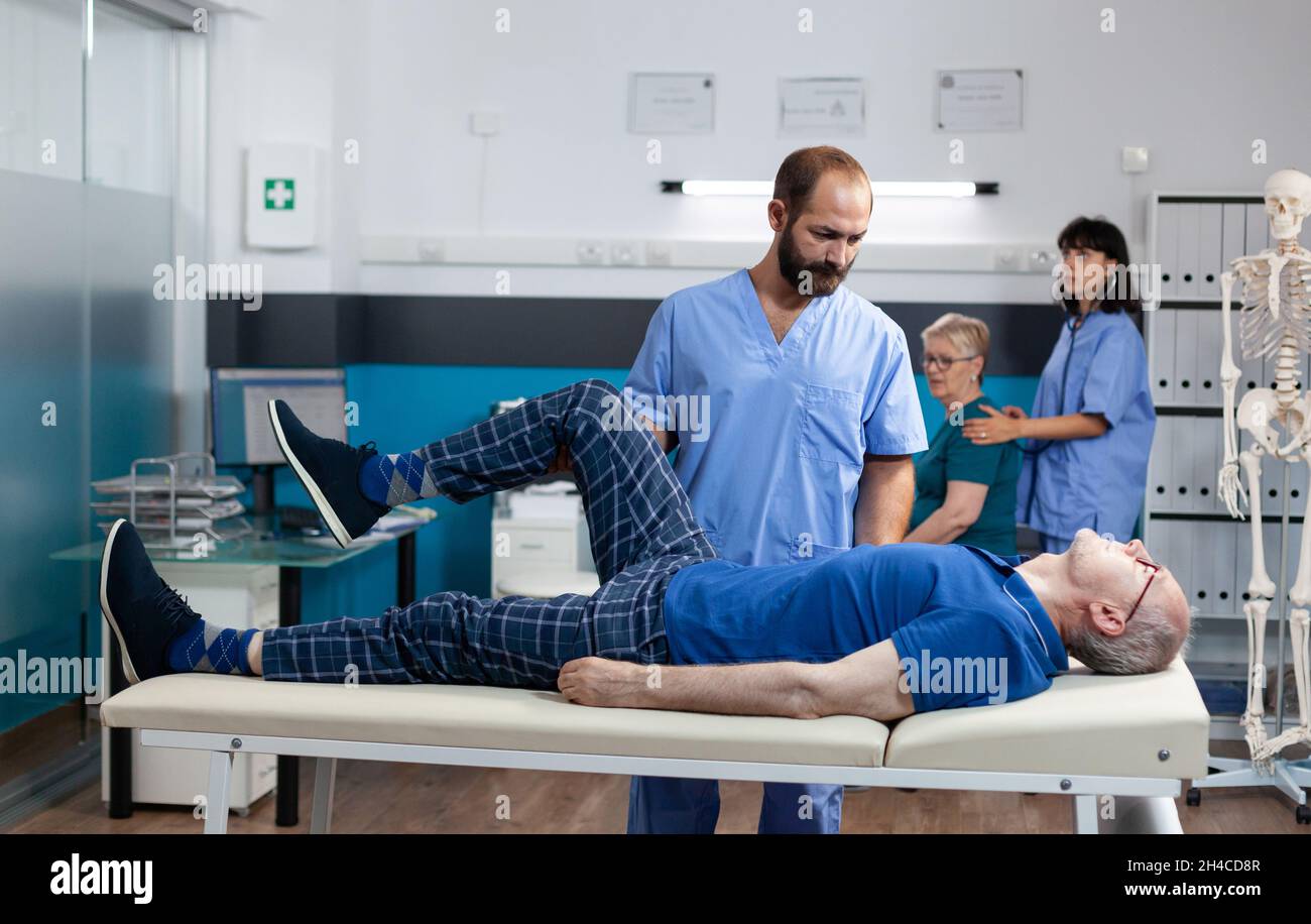 Man with leg muscle injury receiving orthopedic massage for ...