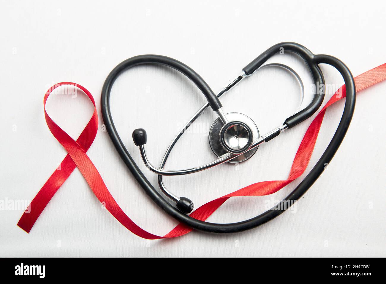 Red ribbon and stethoscope with white background. Hiv Aids ribbon ...