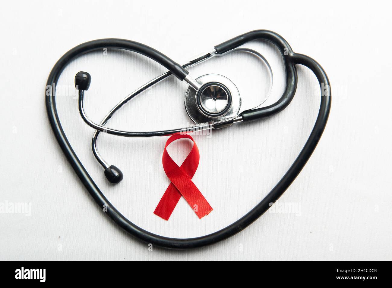 Red ribbon and stethoscope with white background. Hiv Aids ribbon ...