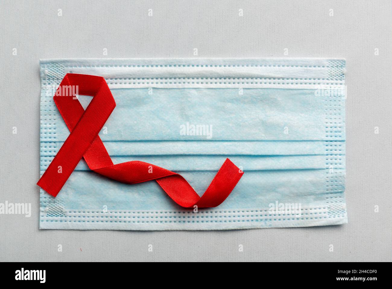 Red ribbon and syringe with white background. Hiv Aids ribbon awareness ...