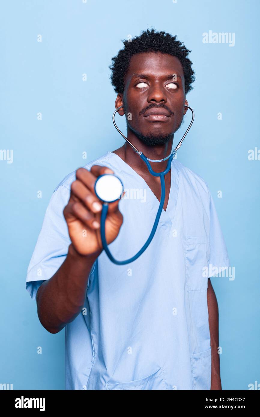 Goofy nurse holding stethoscope while rolling eyes. Healthcare ... Goofy nurse holding stethoscope while rolling eyes. Healthcare ...