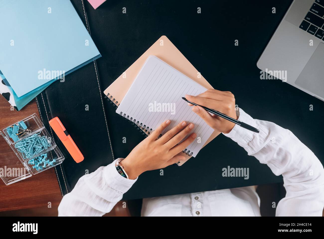 Business woman writing something in notebook. Top view Stock Photo - Alamy