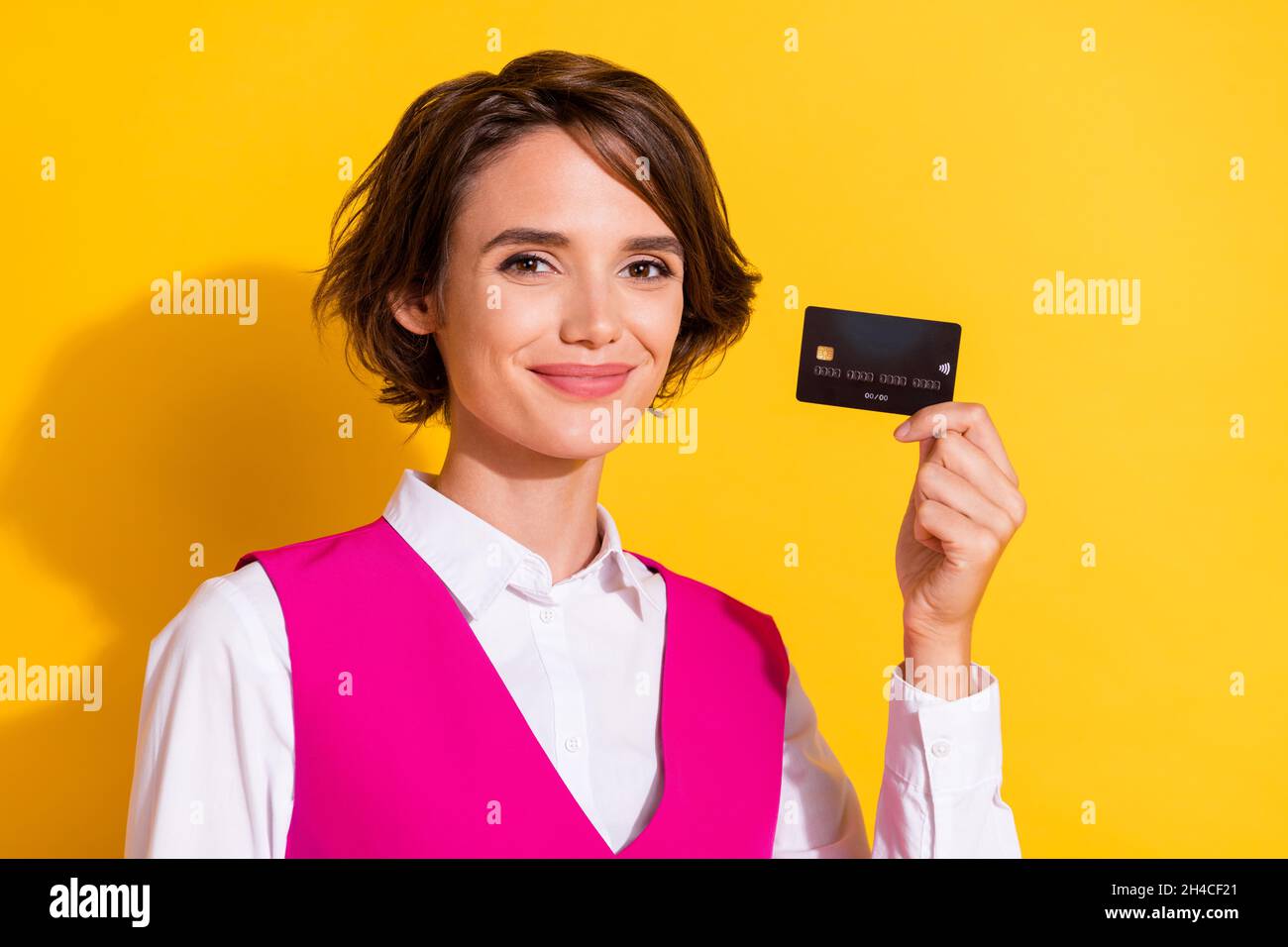 Photo of cute charming young lady wear pink suit smiling holding bank ...