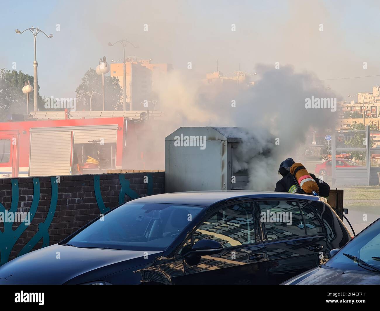A firefighter runs down the street to the source of the fire Stock ...