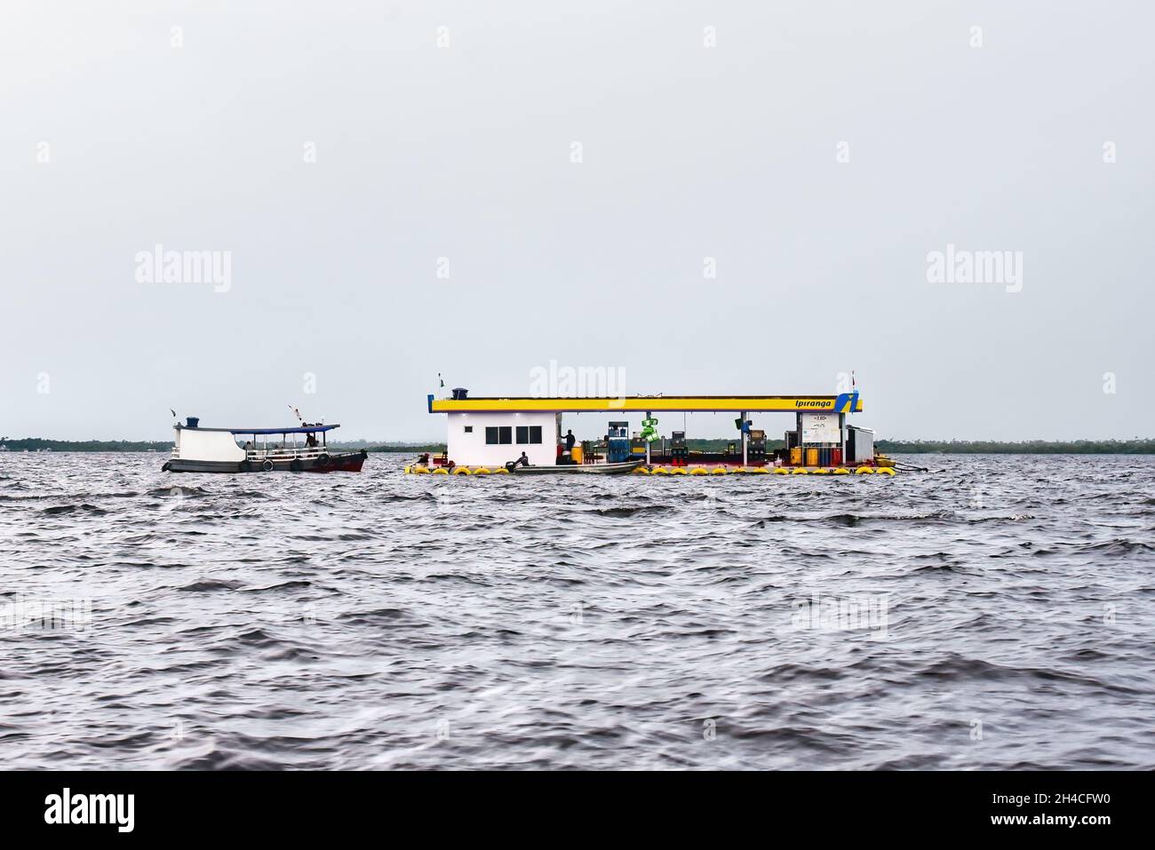 A boat waiting to fill the fuel at Floating Petrol Station Ipiranga, on ...