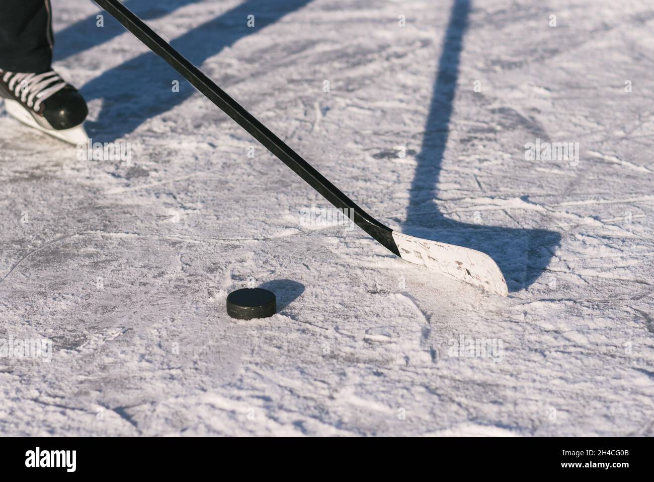 close-up stick and puck on the ice background Stock Photo - Alamy