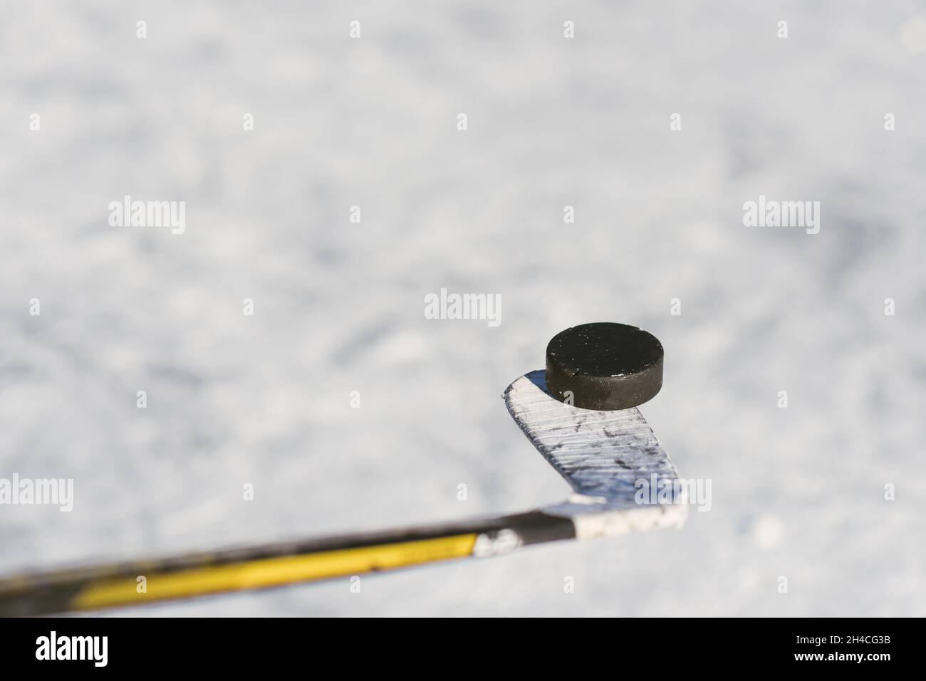 close-up stick and puck on the ice background Stock Photo - Alamy