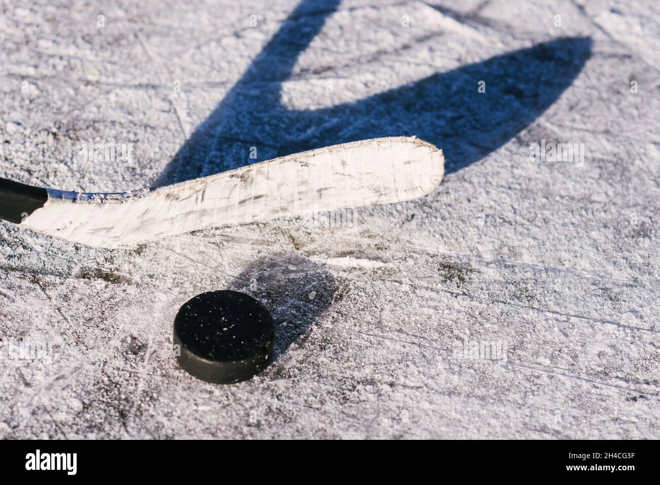 close-up stick and puck on the ice background Stock Photo - Alamy