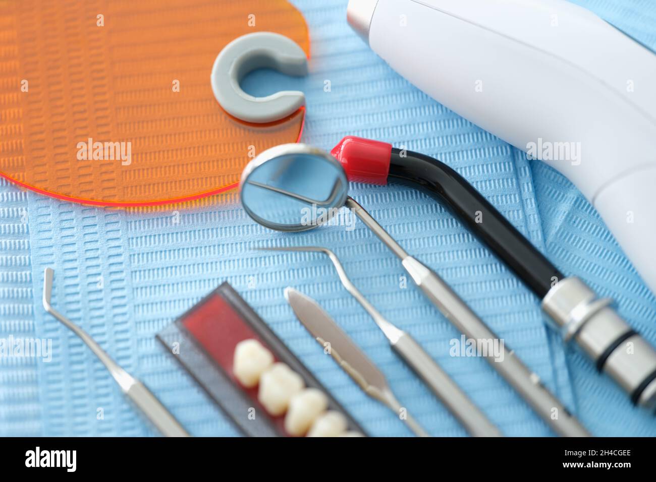 Dental instruments and denture lie on a blue medical napkin Stock Photo ...