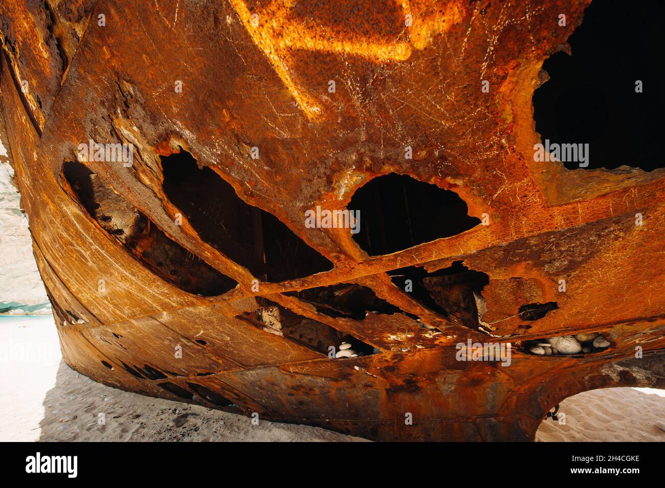 Rusted with holes, the ship is on the sea shore.Rusty ship in the Bay ...