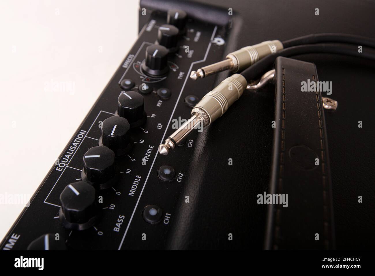 Black electric amplifier with cable on white background Stock Photo - Alamy