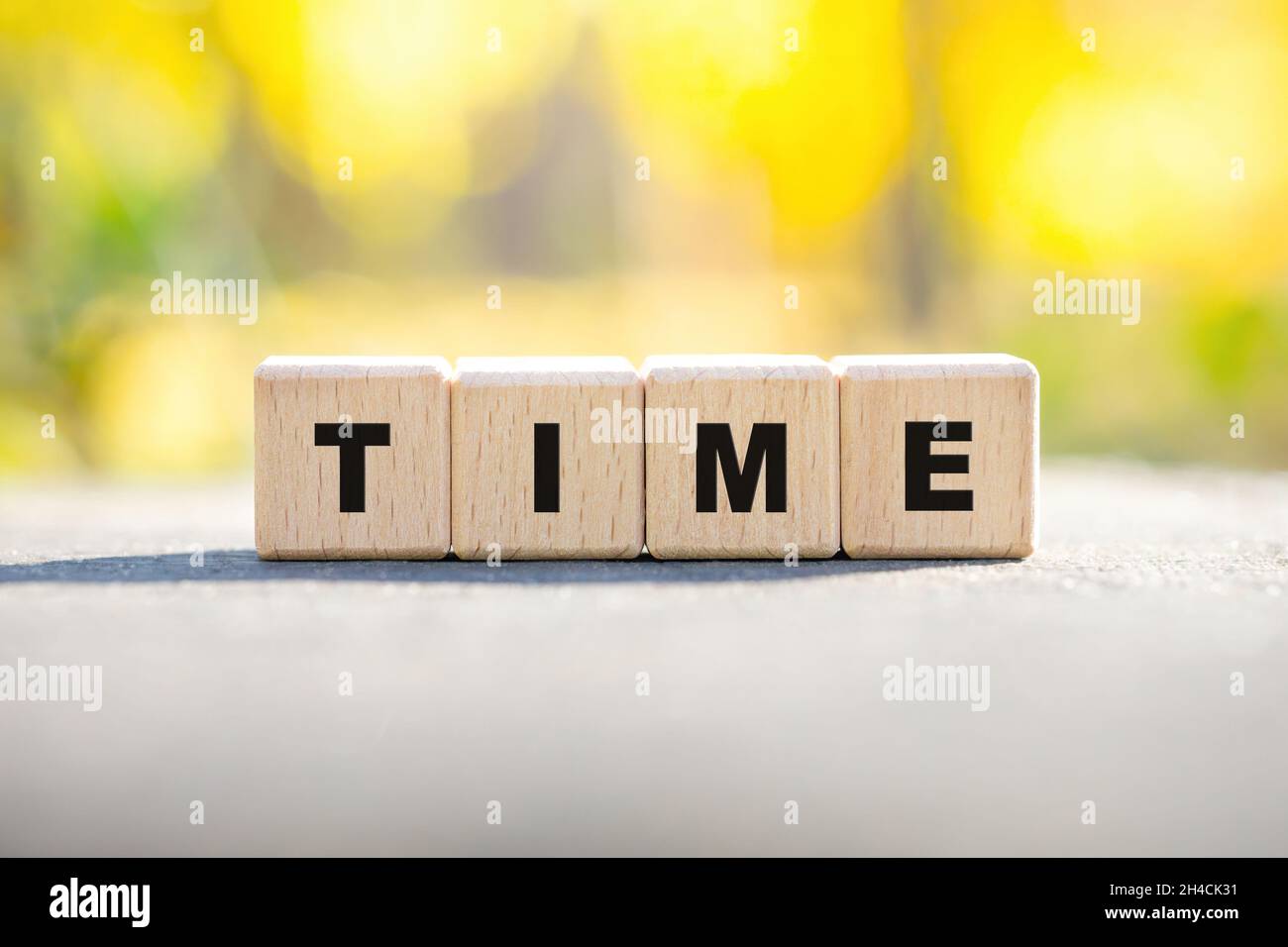 Word TIME made of wooden alphabet blocks outdoors. Autumn season ...
