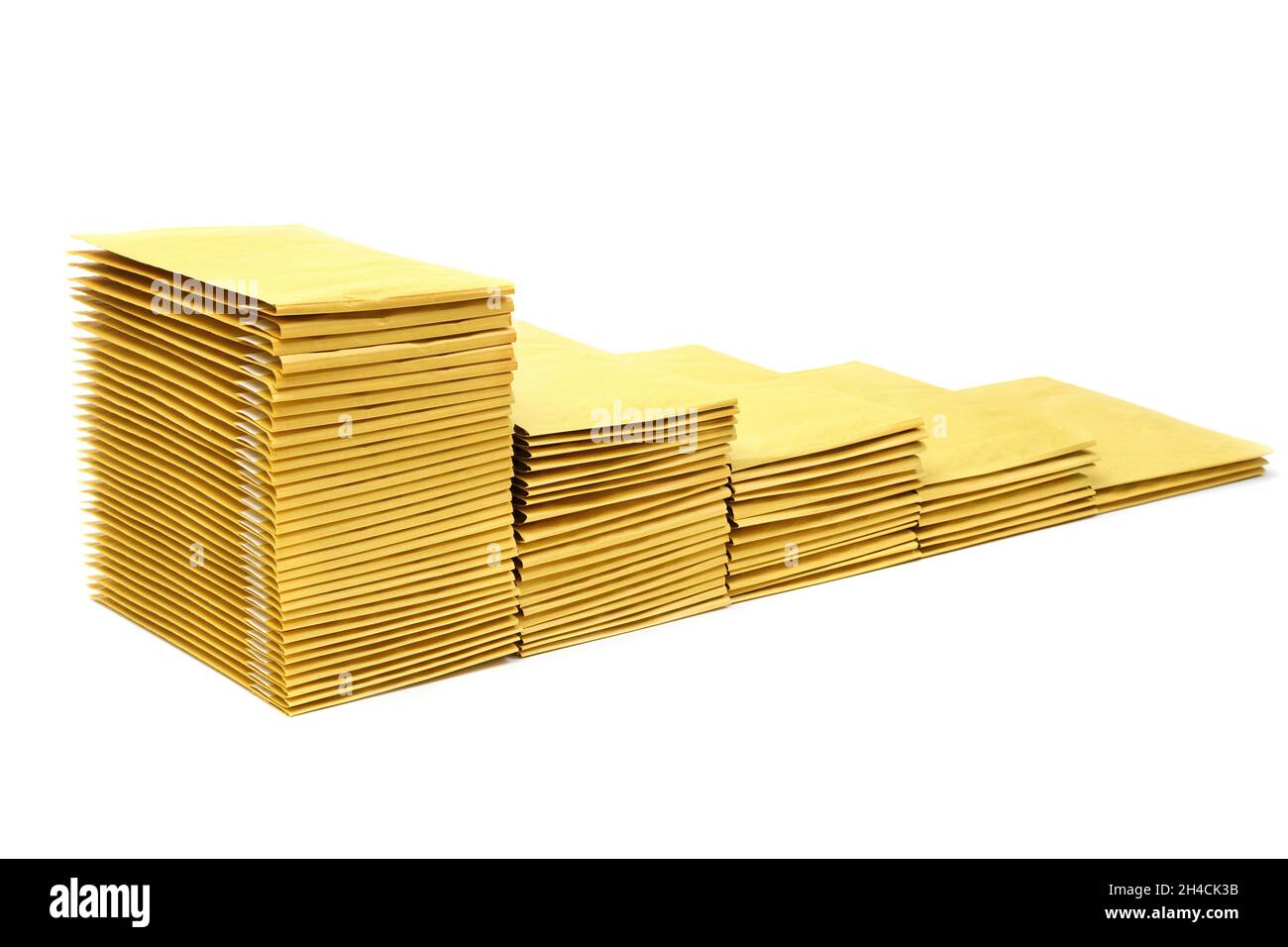 Stacks of padded mail envelopes of different heights isolated on white ...