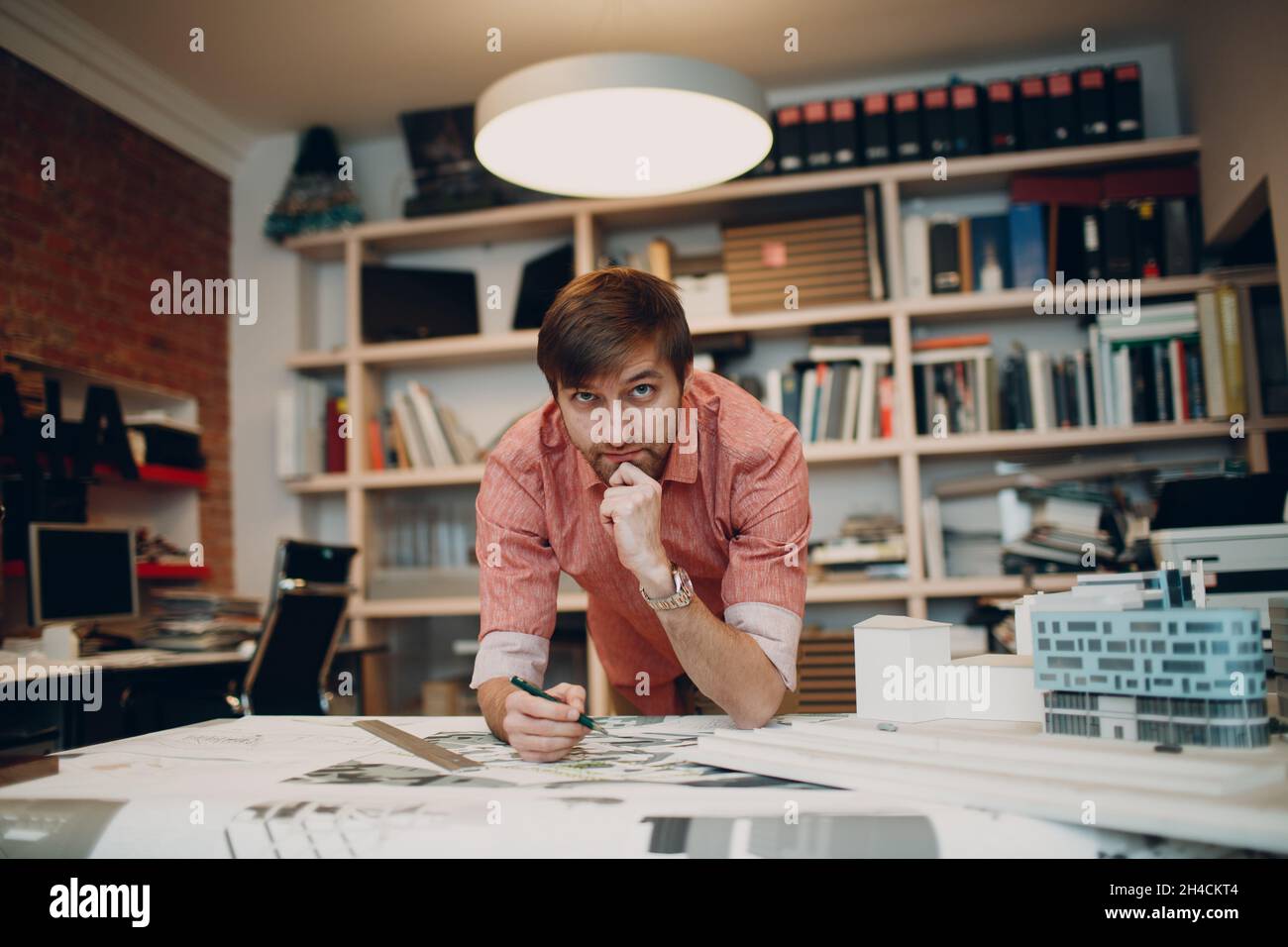 Architect with blueprints and layout design project at office bureau ...