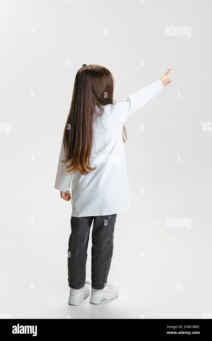 Back view. Cute beautiful little girl, child in image of doctor wearing ...