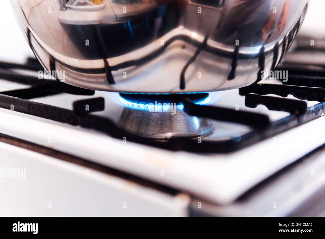 selective view of butane gas burner with blue flame. gas price ...