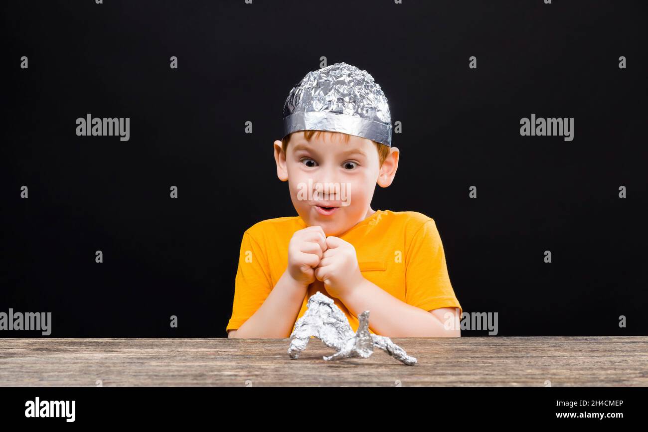 a beautiful red-haired boy with a homemade aluminum foil hat, a boy ...