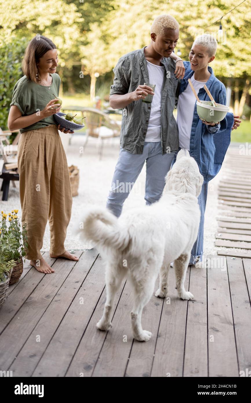 Friends enjoying time together at home backyard Stock Photo - Alamy