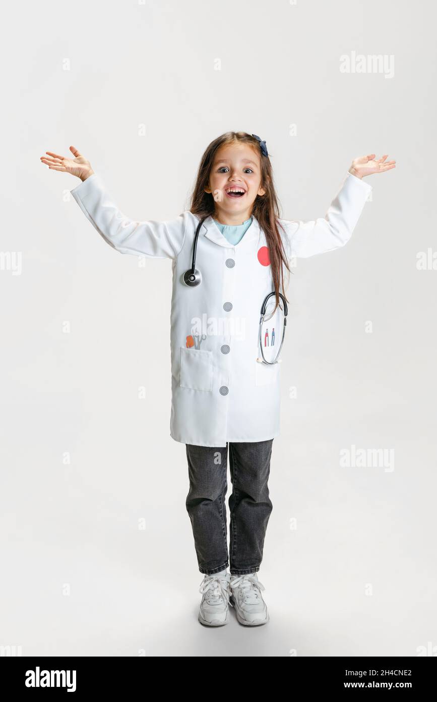 Preschool beautiful girl, child in image of doctor wearing white lab ...