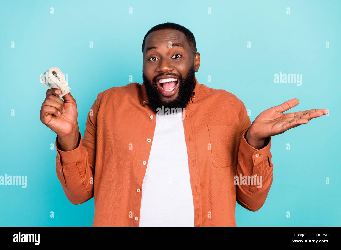 Photo of young excited black man happy positive smile rich dollars ...
