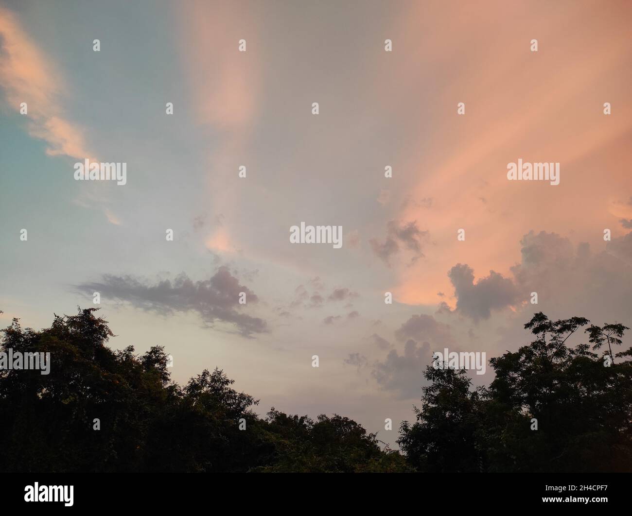 Beautiful scene of clouds in the sky at sunset Stock Photo - Alamy