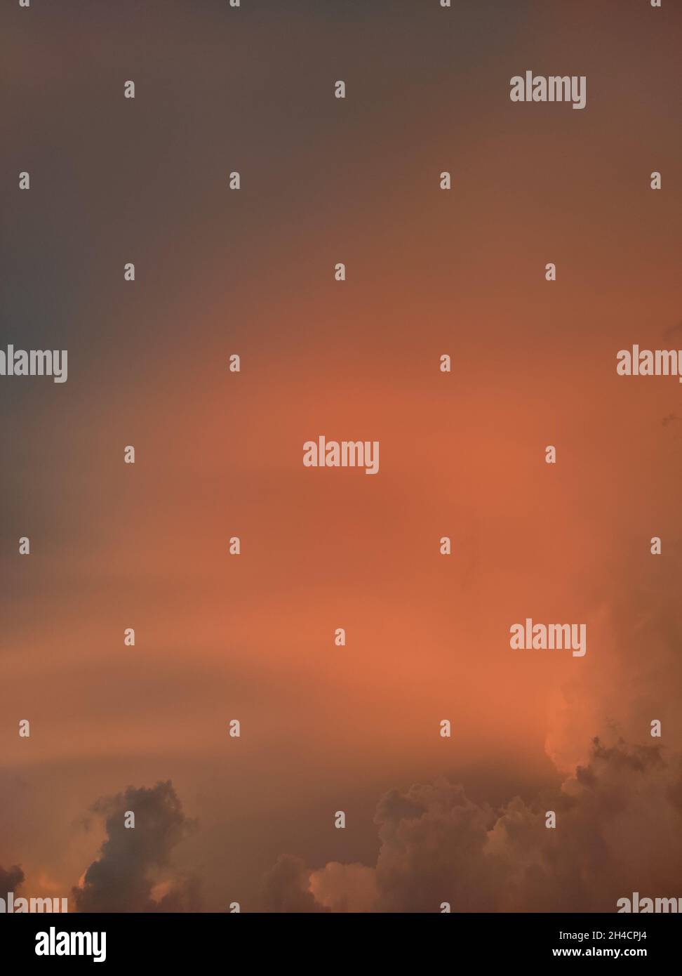 Beautiful scene of clouds in the sky at orange sunset Stock Photo - Alamy