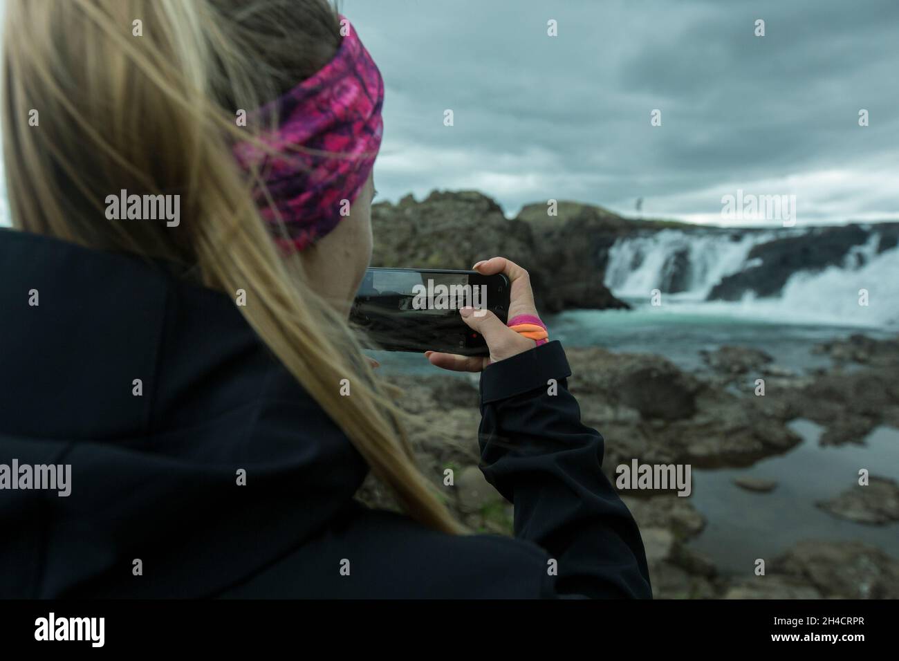Emotions next to a waterfall in Iceland, wild strong nature, boy is ...