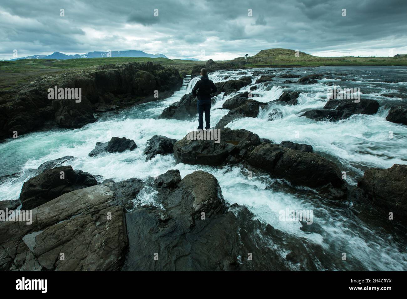 Emotions next to a waterfall in Iceland, wild strong nature, boy is ...