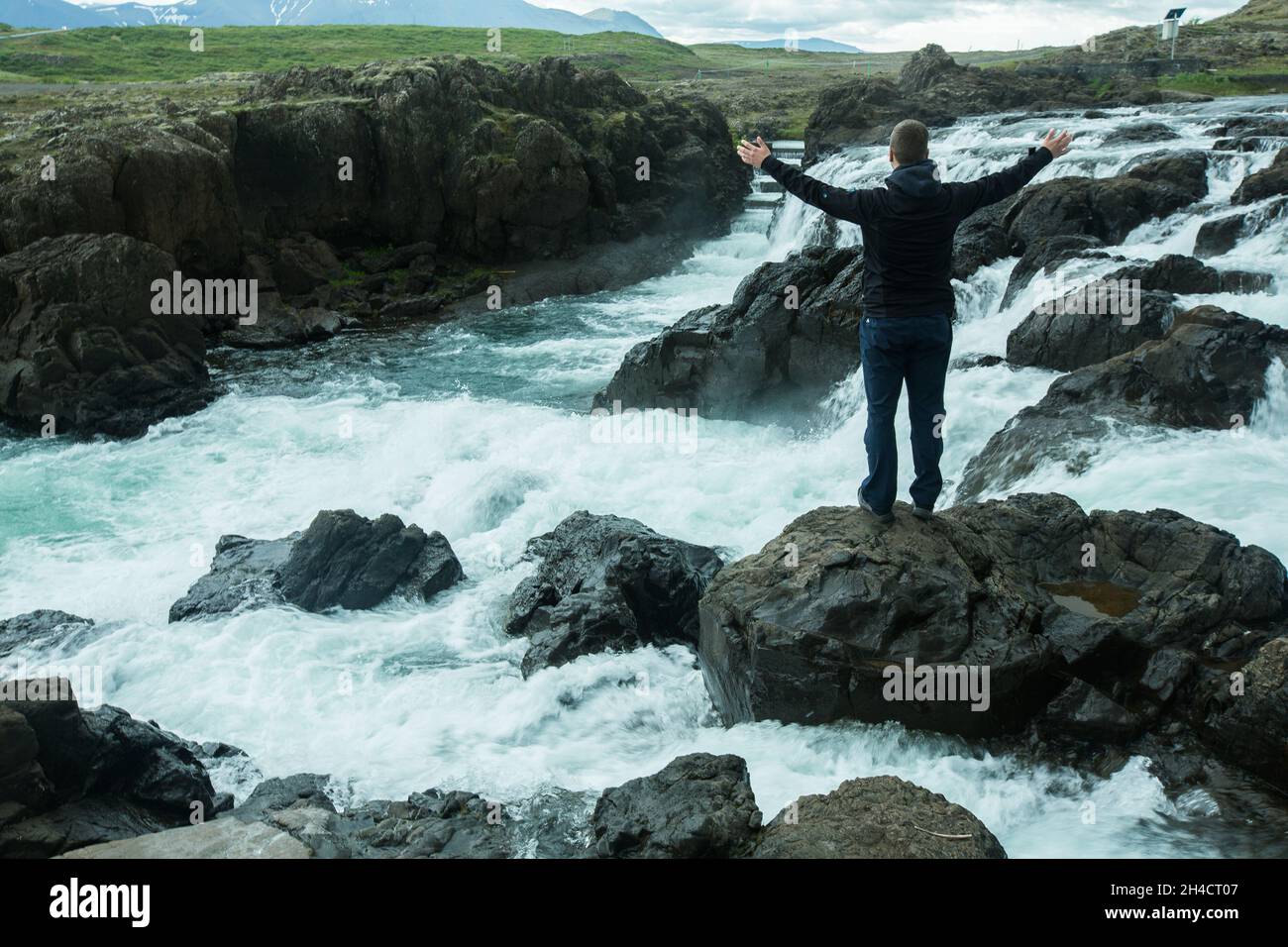 Emotions next to a waterfall in Iceland, wild strong nature, boy is ...