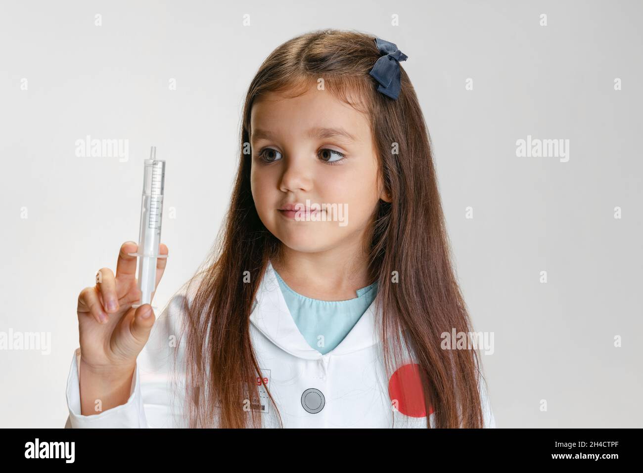 Portrait of cute beautiful girl, child in image of doctor wearing white ...