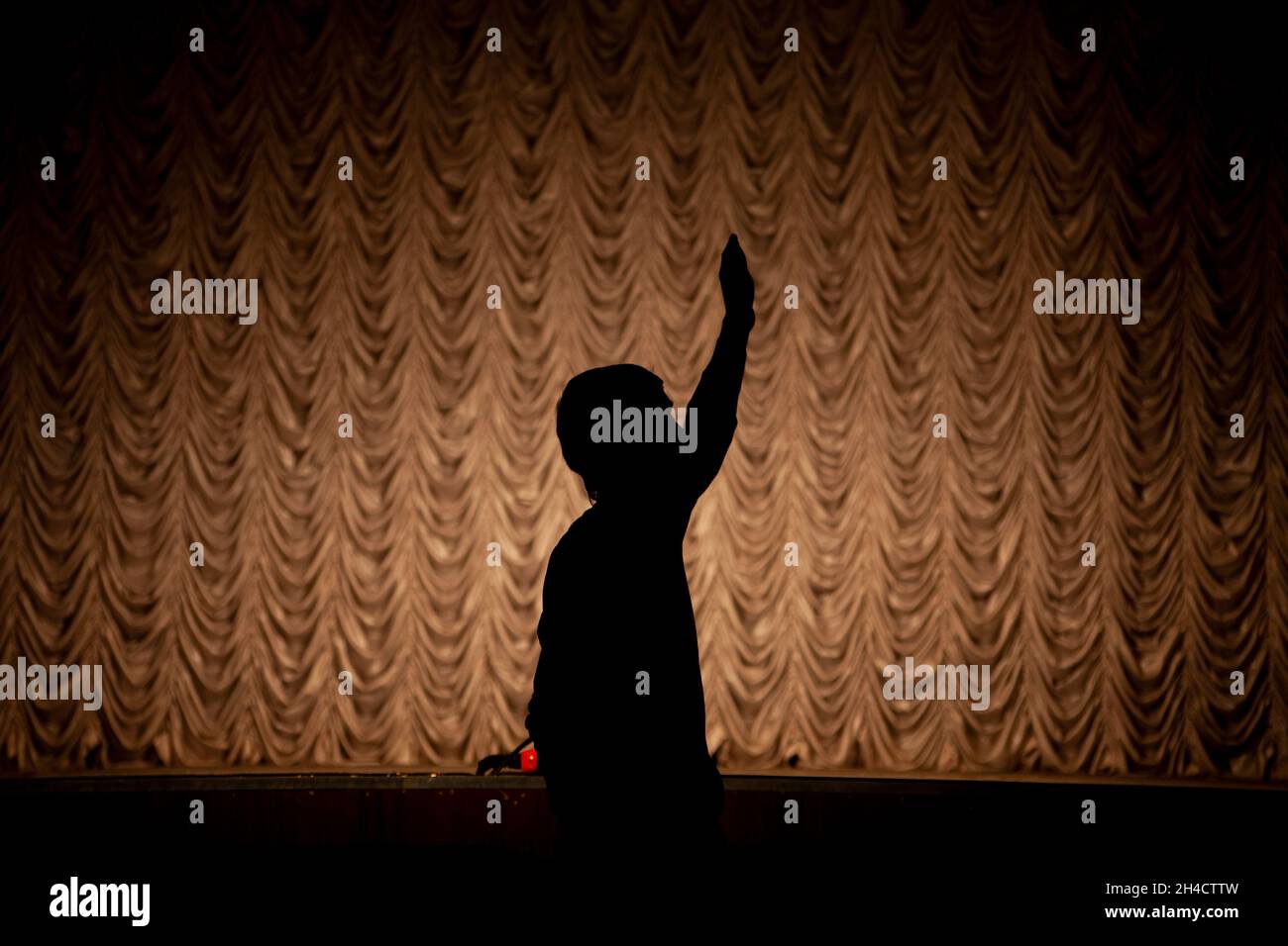Silhouette of the director. A man directs a play. Hand gesture. Young ...