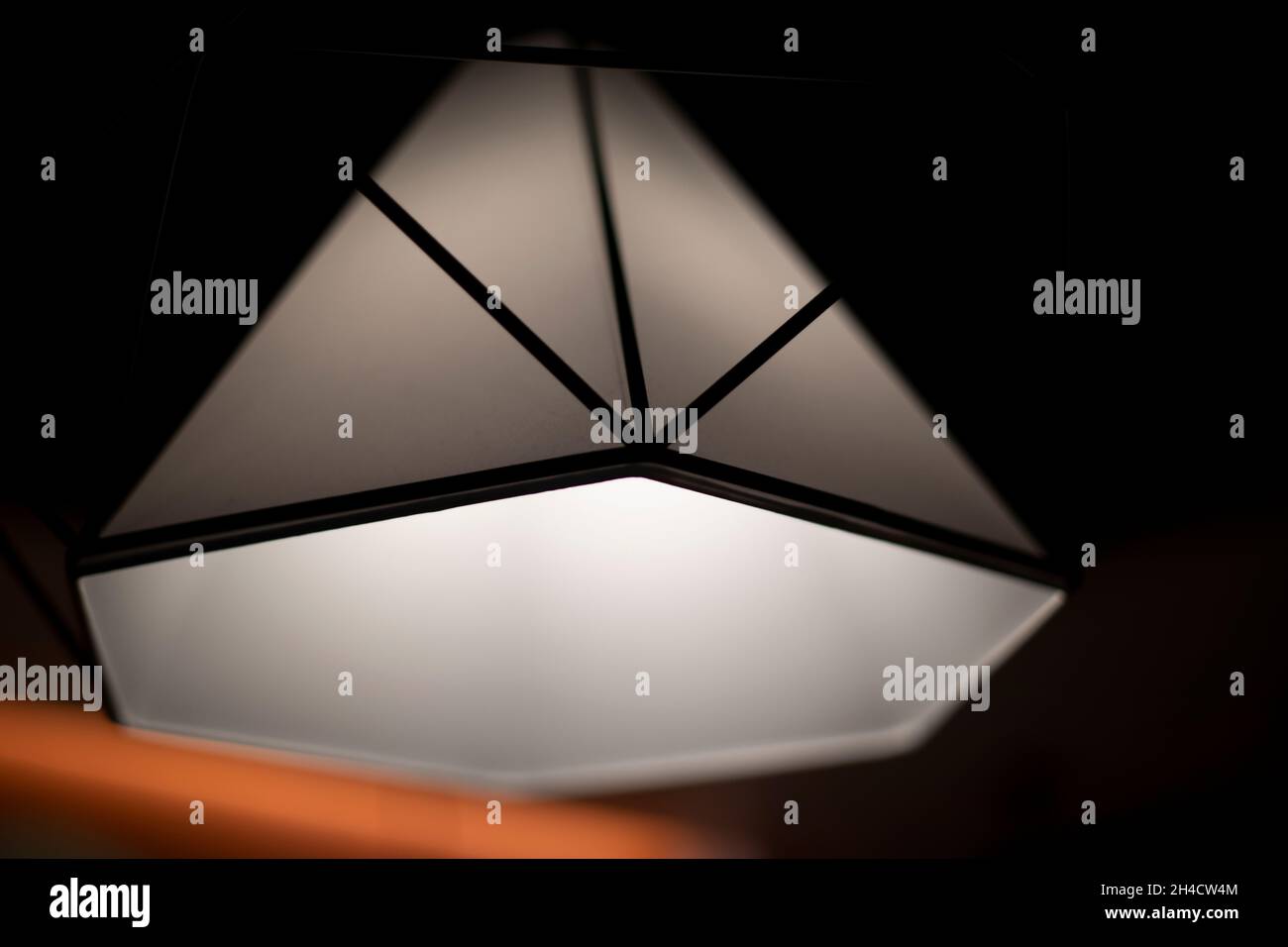 Designer lamp. Cold light in the restaurant. Beautiful lamp under the ...