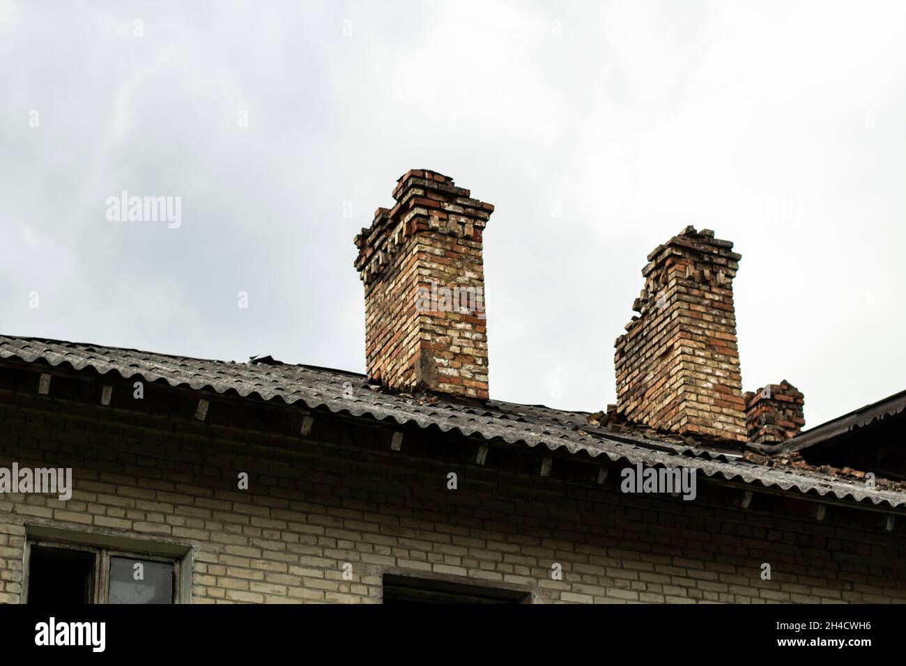 Old roof with chimneys. Old house. A crumbling building Stock Photo - Alamy
