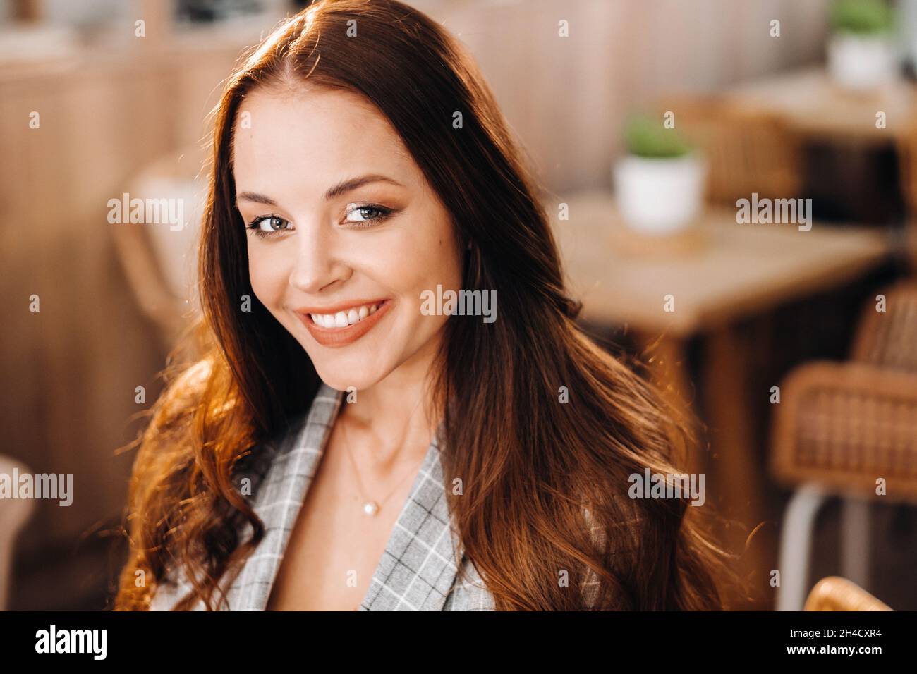 portrait of an Attractive young woman who is sitting in a cafe. Cafe ...