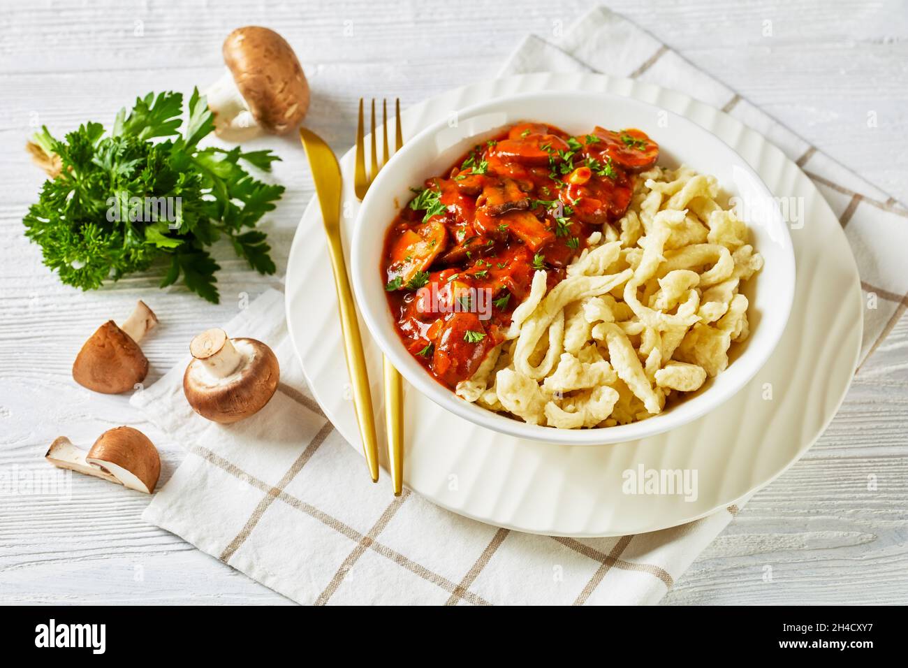 spaetzle with mushroom gravy in a white bowl, jagerspatzle ...