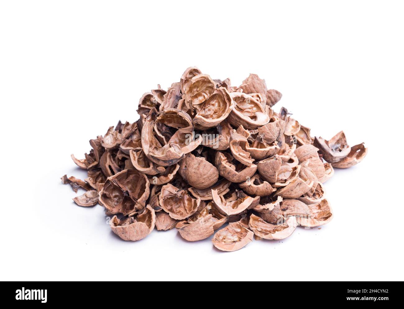 Pile of empty broken walnut shells isolated on white Stock Photo - Alamy