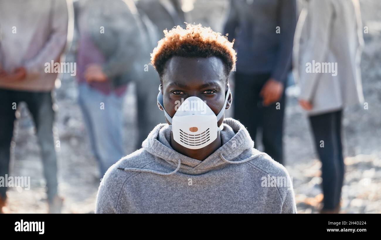 Portrait of a Sad Black Young Man in Gas Mask Standing in Toxic Smoke ...