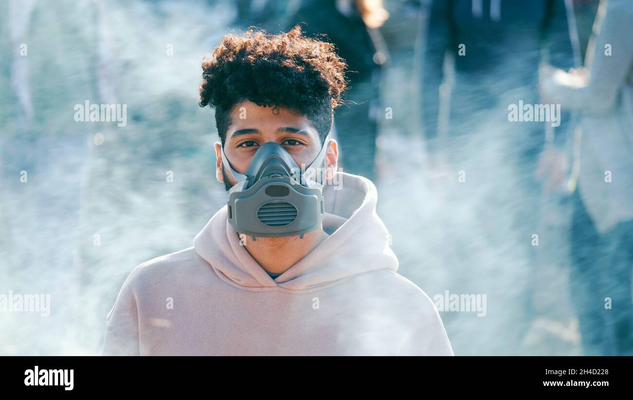 Portrait of a Sad Black Young Man in Gas Mask Standing in Toxic Smoke ...
