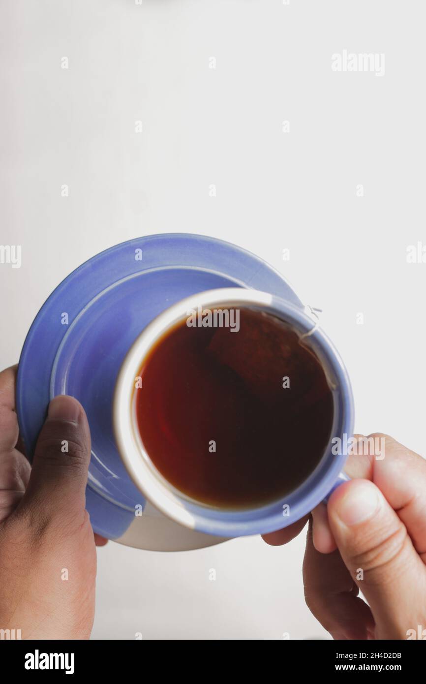 flat lay, close up two hands holding the teacup Stock Photo - Alamy