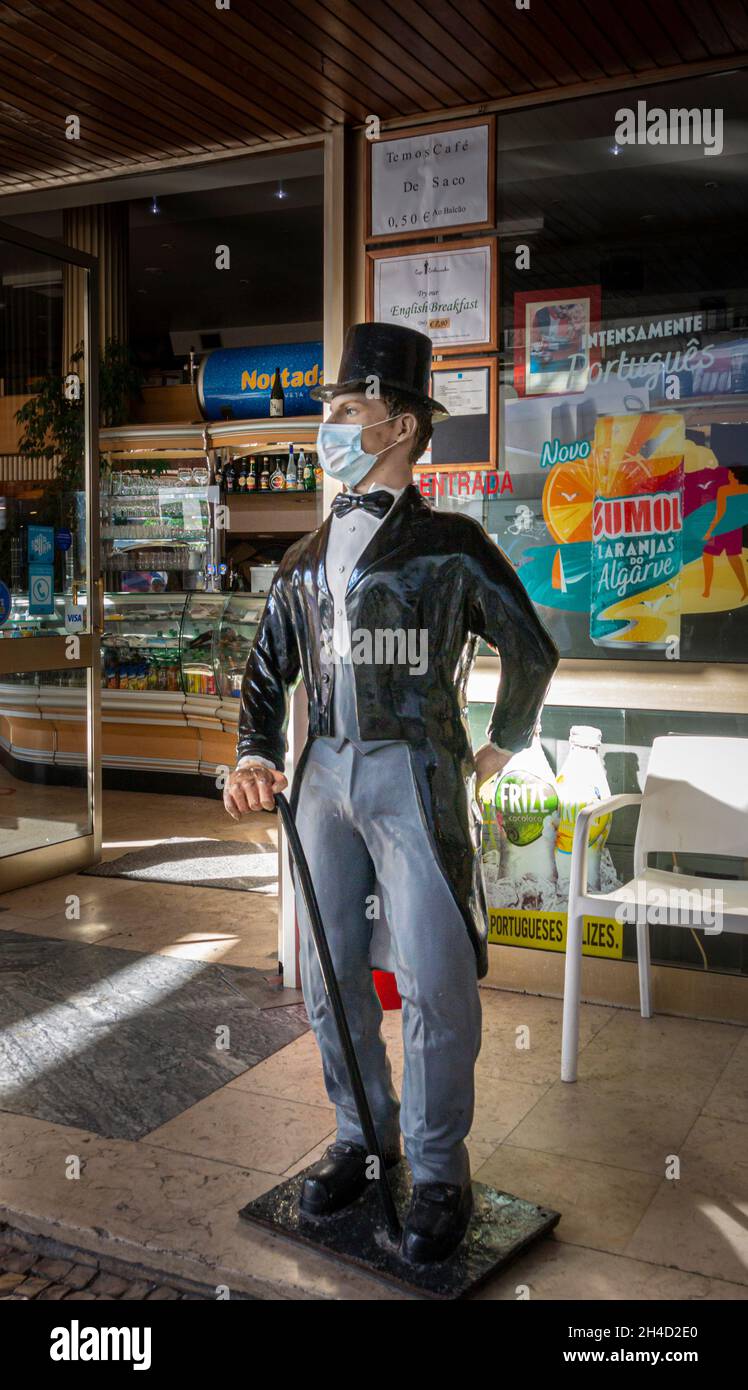 Statue of a well dressed man in top hat and tails, wearing a mask Stock ...