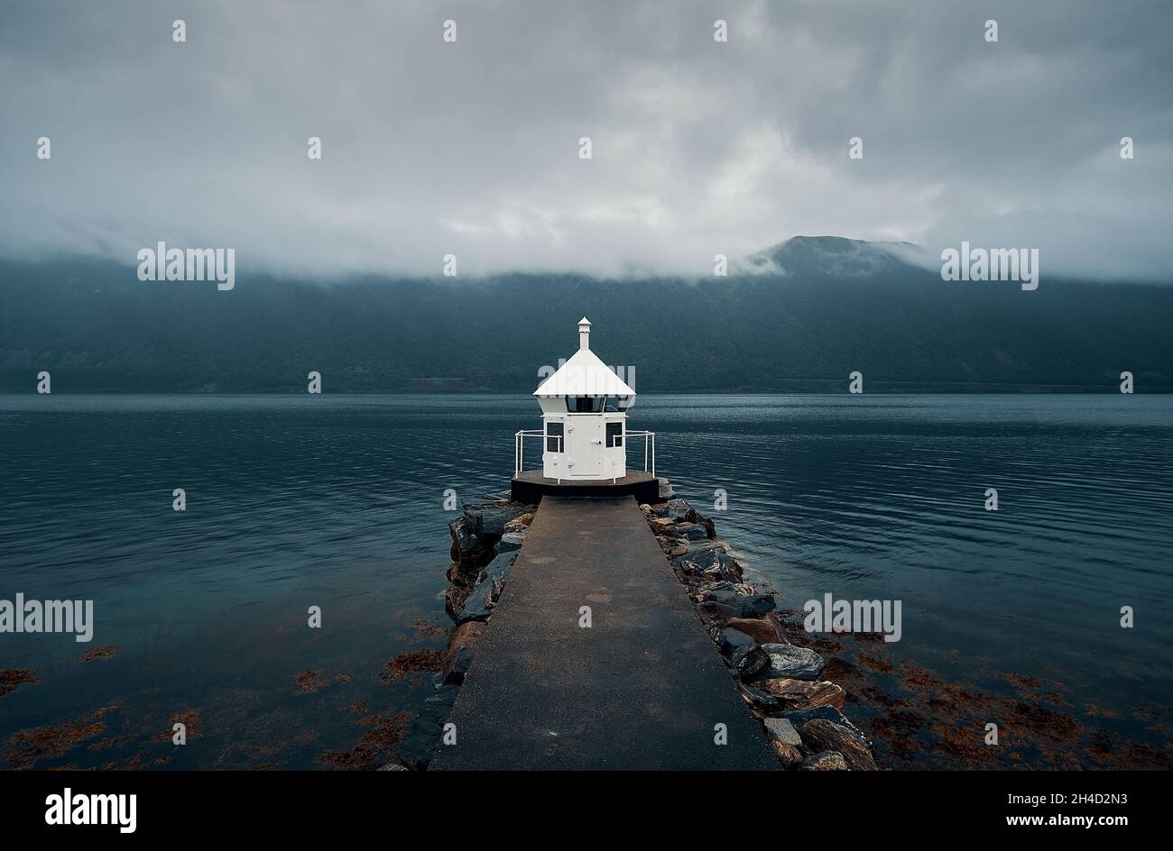 Lighthouse inside a fjord on a rainy day, Norway Stock Photo - Alamy