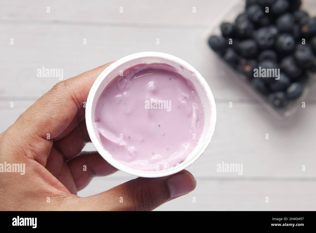 hand hold fresh yogurt in a plastic container Stock Photo - Alamy